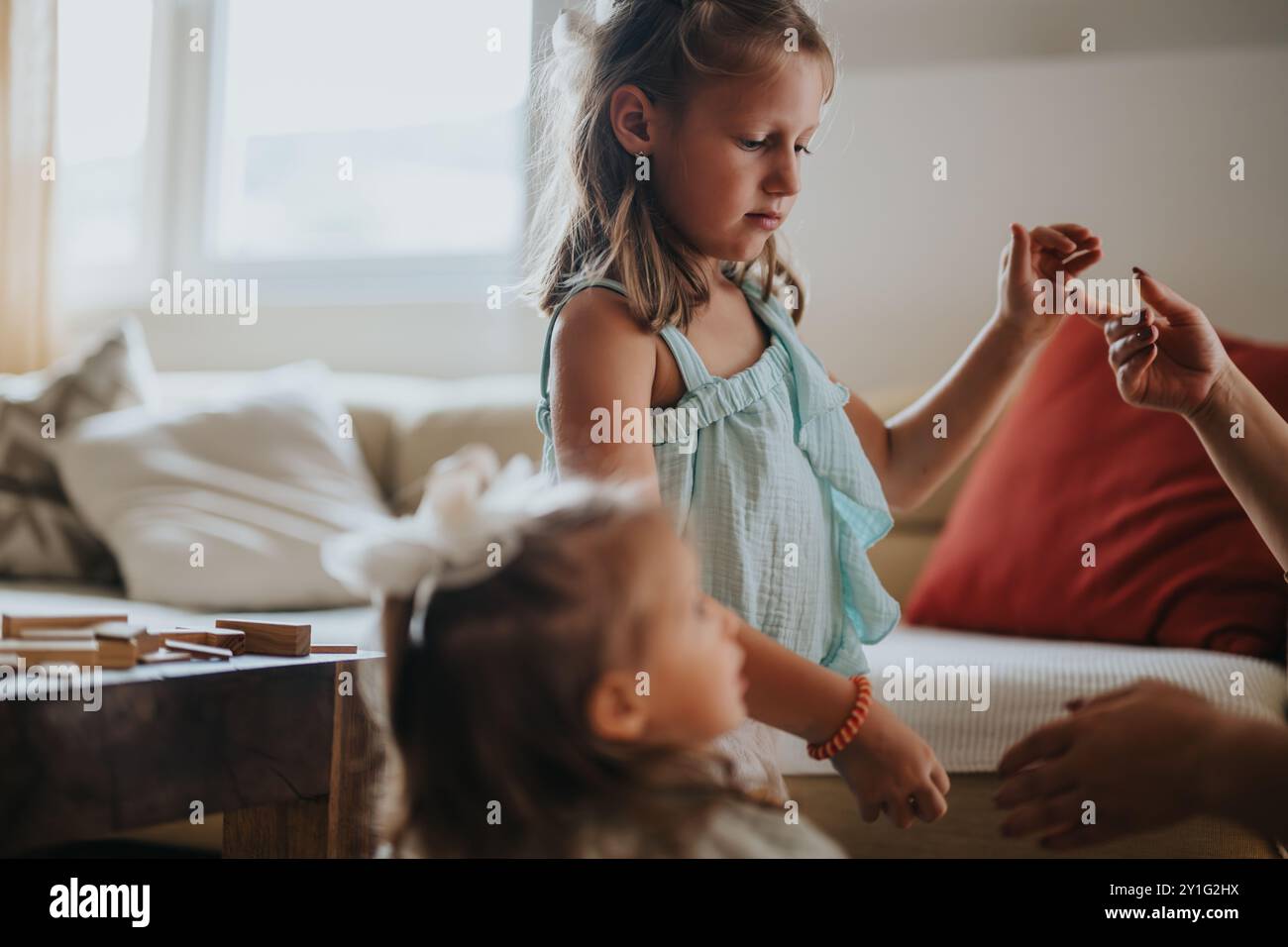 Mom and daughters enjoying quality time together at home Stock Photo ...