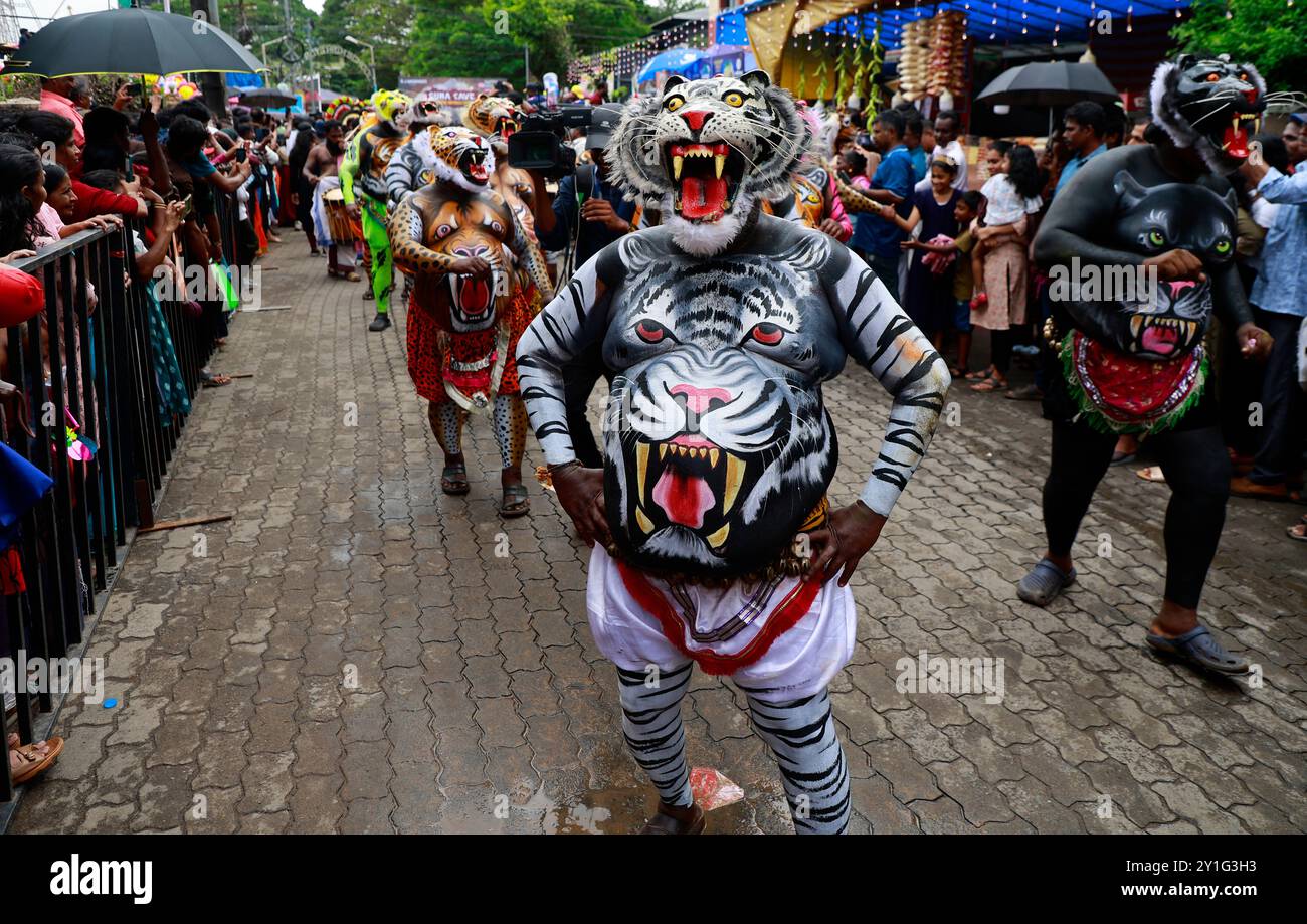 Performers painted to look like tigers dance during Athachamayam ...