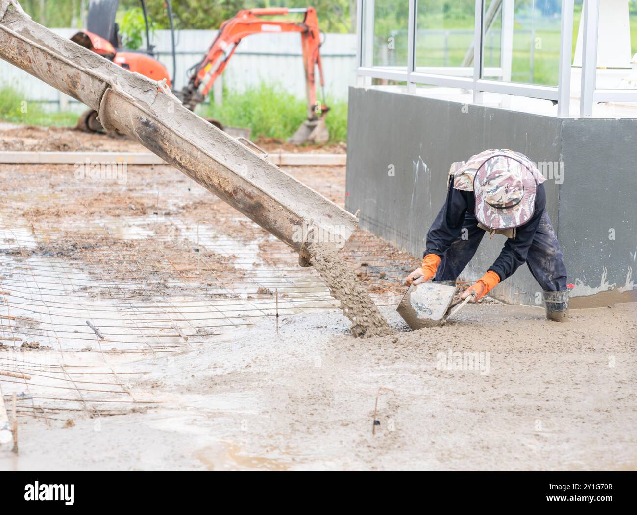 Worker scoop wet concrete spread around in construction site Stock ...