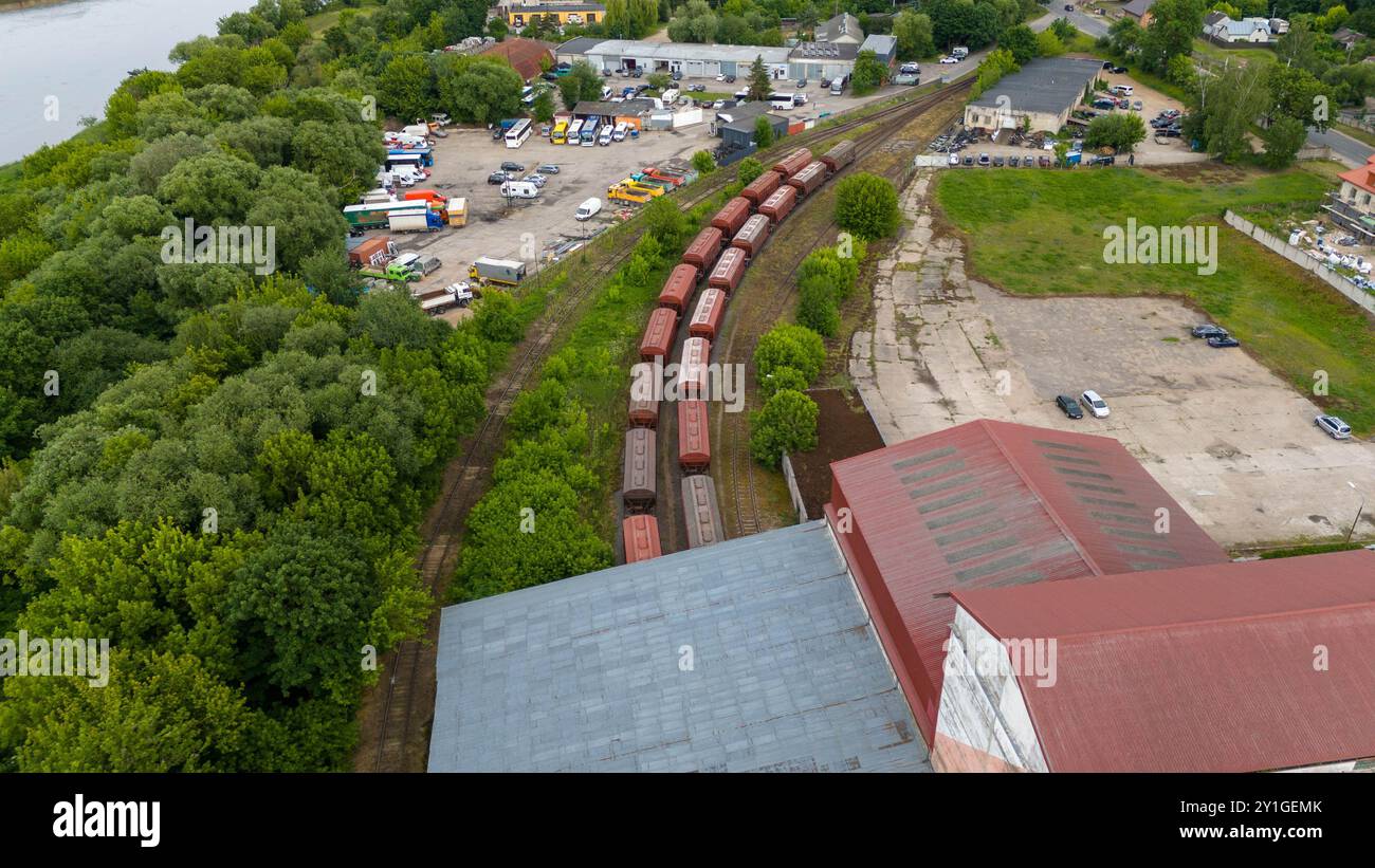 Aerial view of an industrial area featuring large silos, train tracks ...