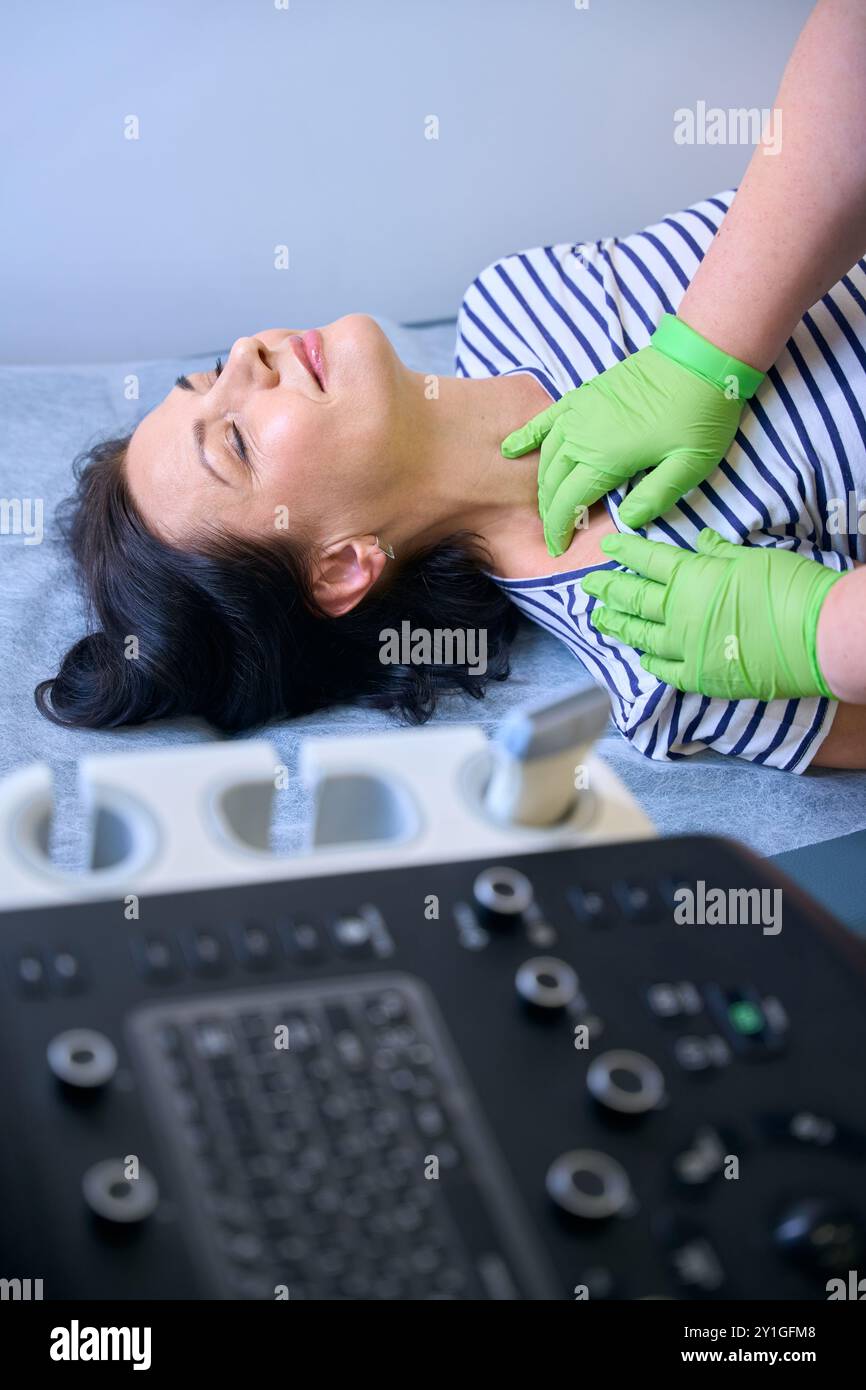 Home doctor at workplace checking patients lymph nodes Stock Photo - Alamy