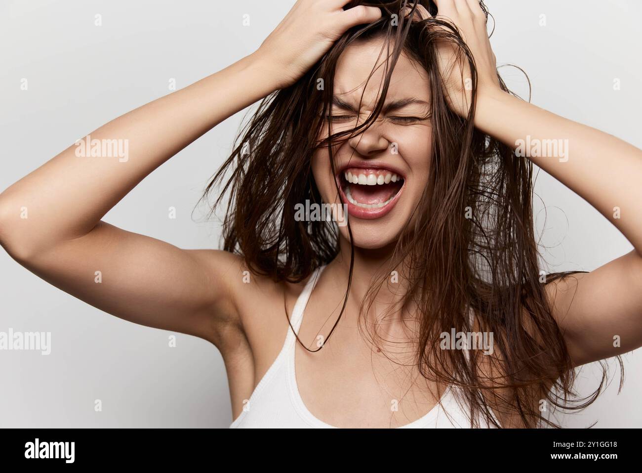 Emotive female portrait expressing joy and laughter, with long, tousled ...