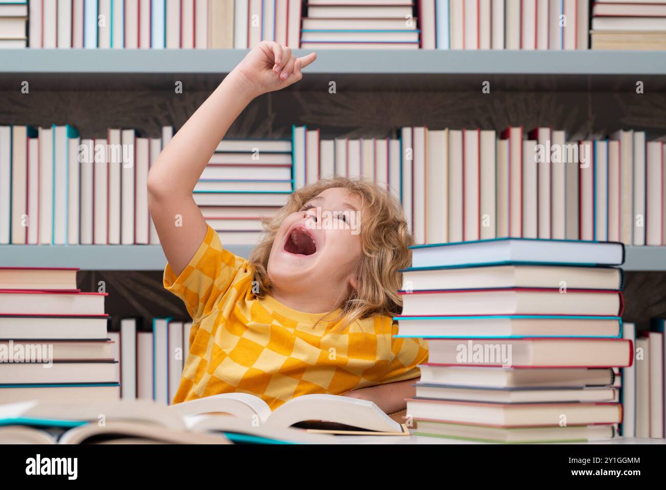 Education Concept. Excited child reading book in a book store or school ...