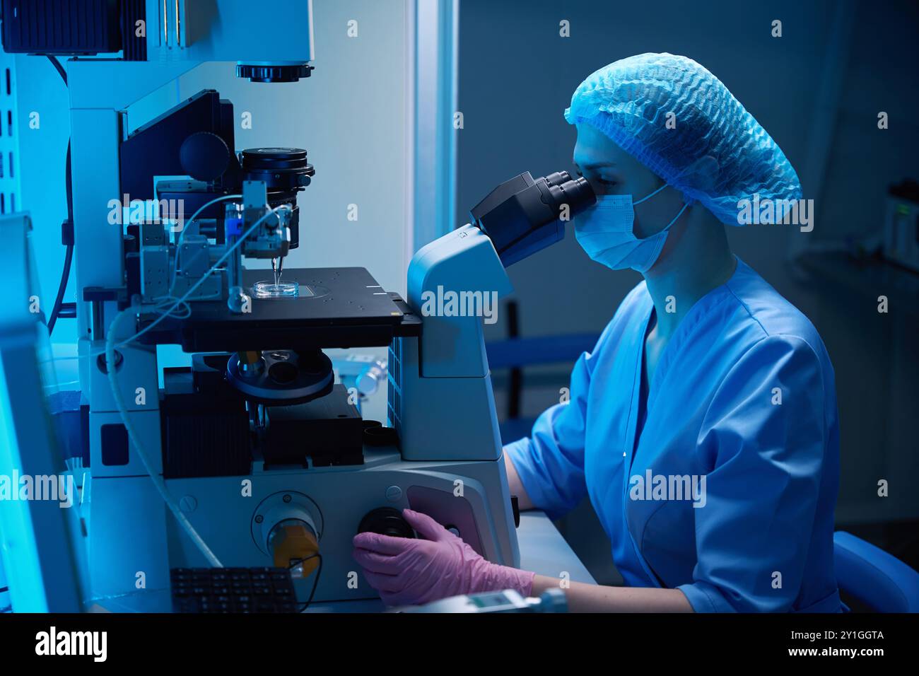Embryologist operating in lab near a cryopreservation system screen ...