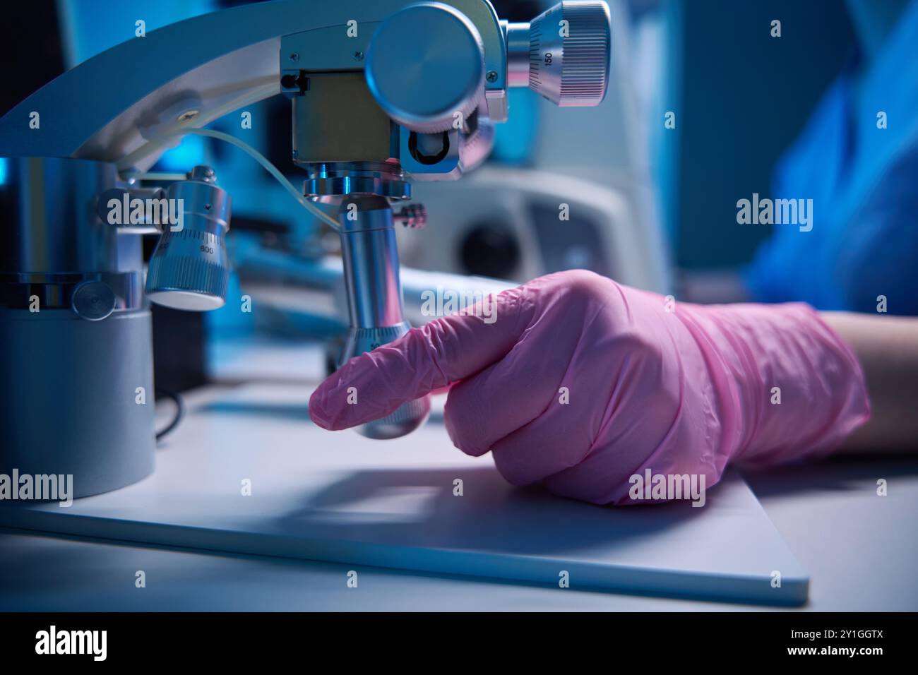 Hand operating a micromanipulator next to a microscope Stock Photo - Alamy