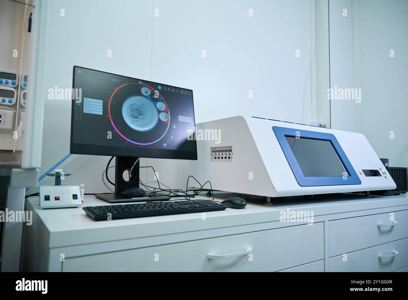 Laboratory equipment and monitor displaying data for embryo development ...