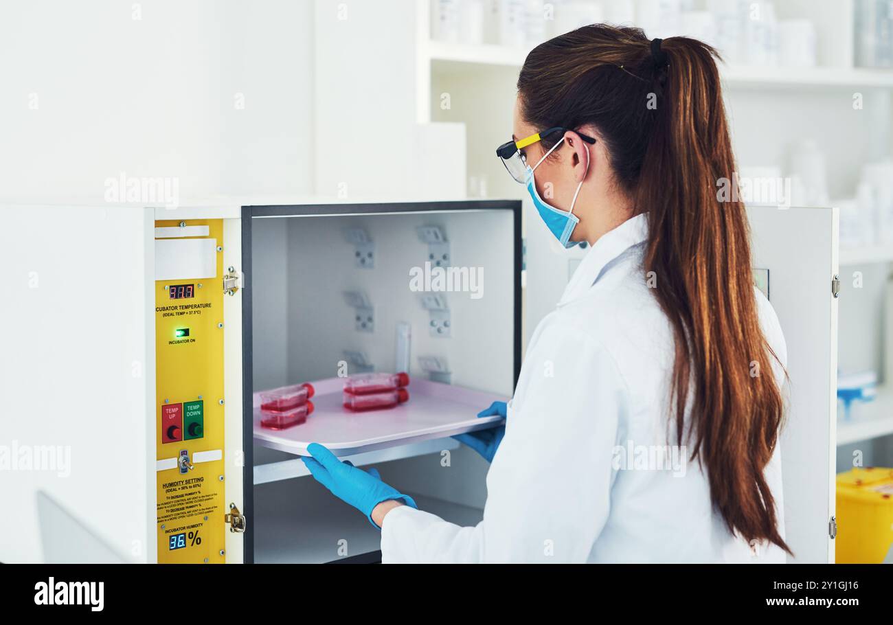 Woman, test and incubator in laboratory for science, control ...