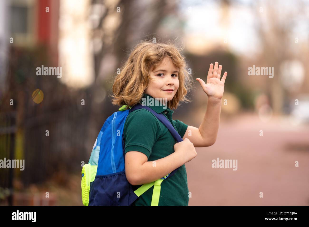 Child getting on the school bus. American School. Back to school. Bye ...
