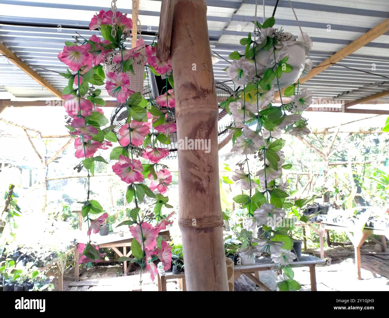 recycled flowers made from plastic hanging from the corners of the ...