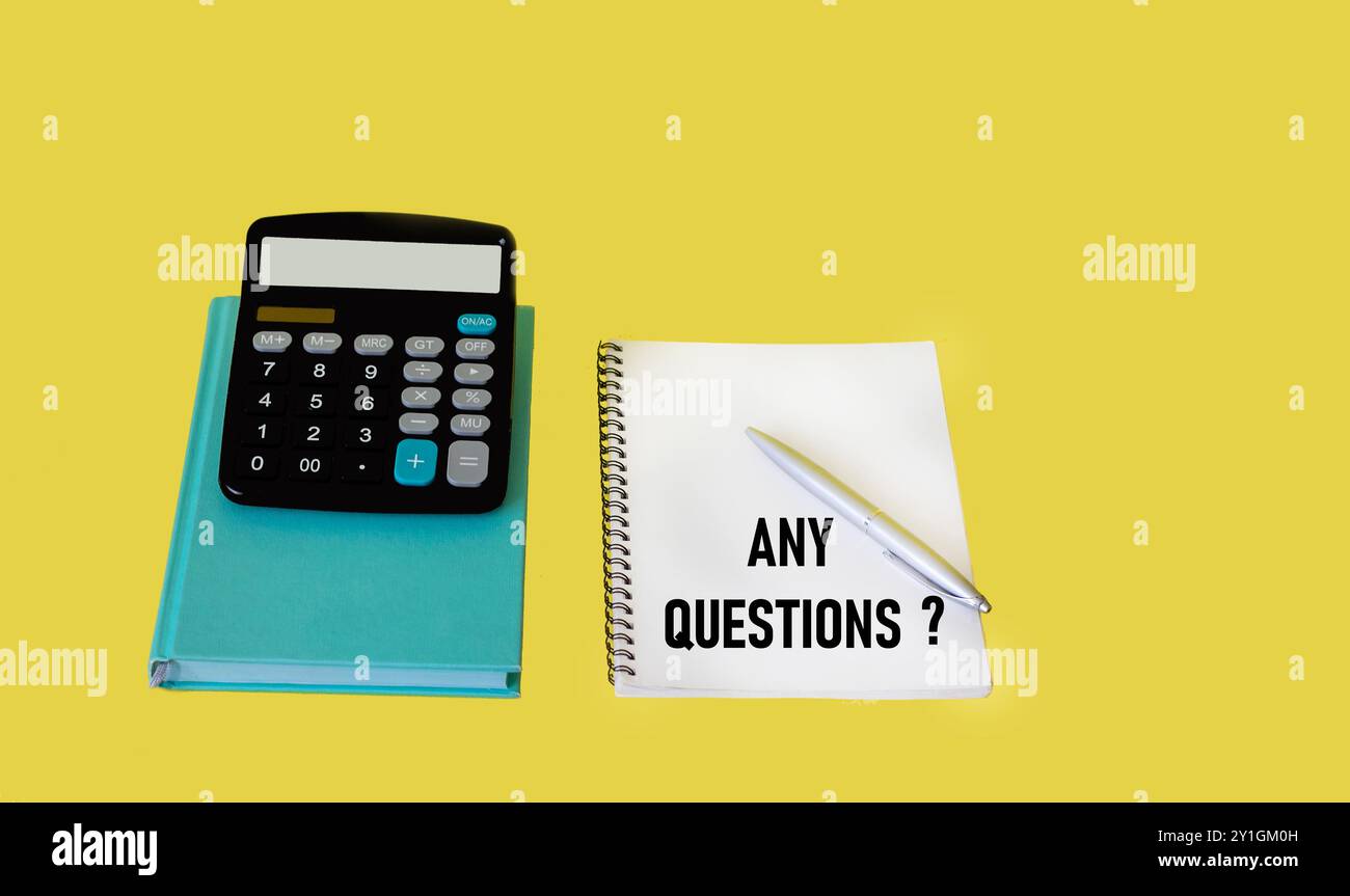 Text ANY QUESTIONS on a notepad on a yellow background with a ...