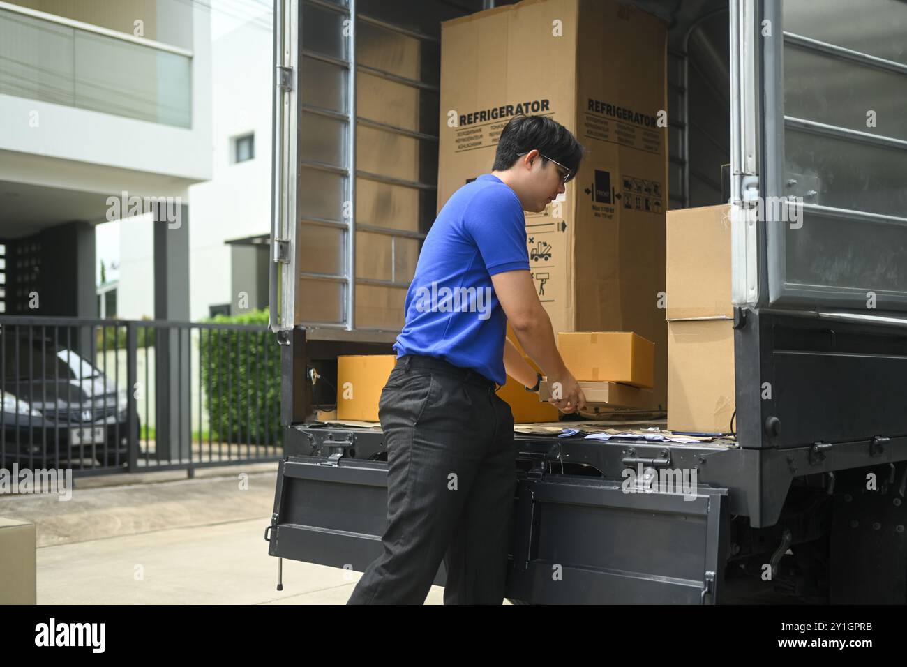 Driver unloading parcels from hi-res stock photography and images - Alamy
