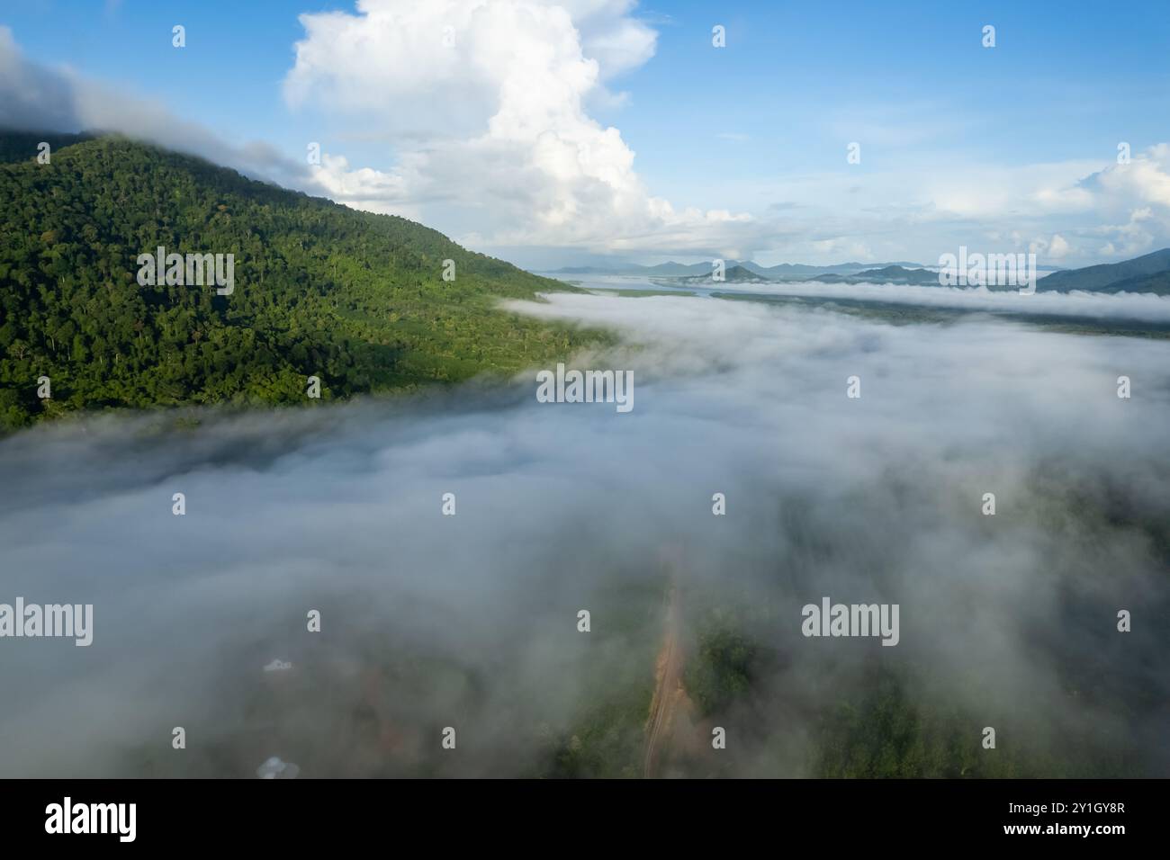 Aerial view drone shot of flowing fog waves on mountain tropical ...