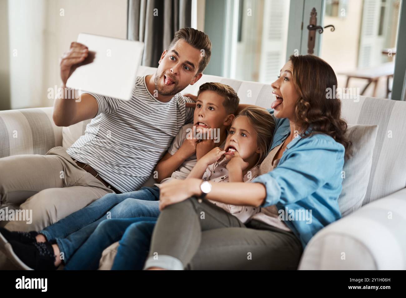 Selfie, goofy and relax with family on sofa for profile picture, social ...