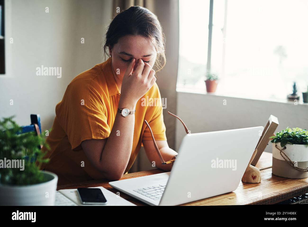 Woman, laptop and stress with eye strain for writing, blog or article ...