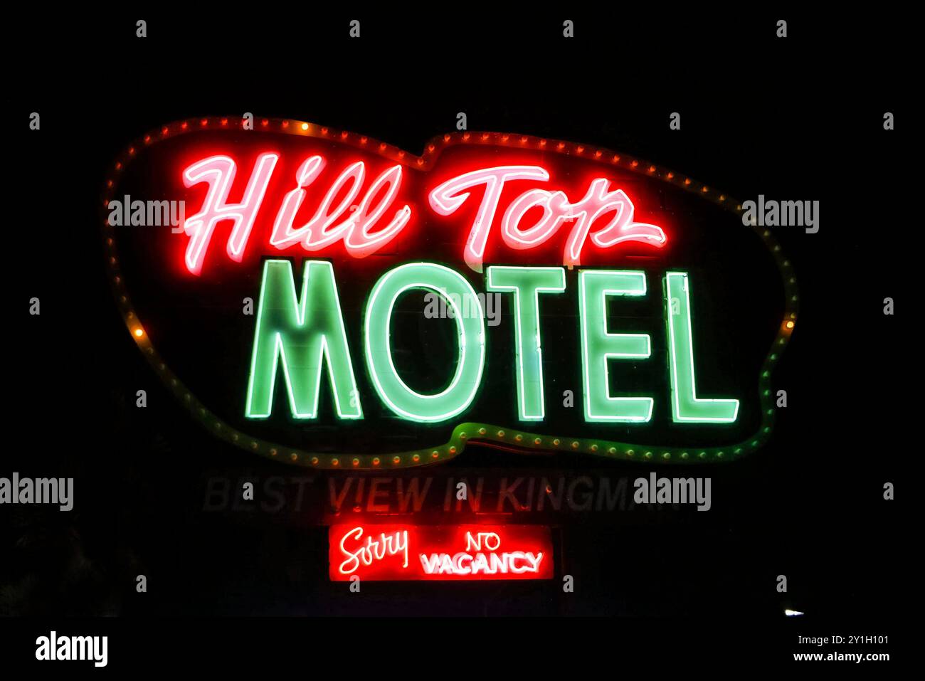 Neon sign of Hill Top Motel glowing in the night with a smaller sign ...