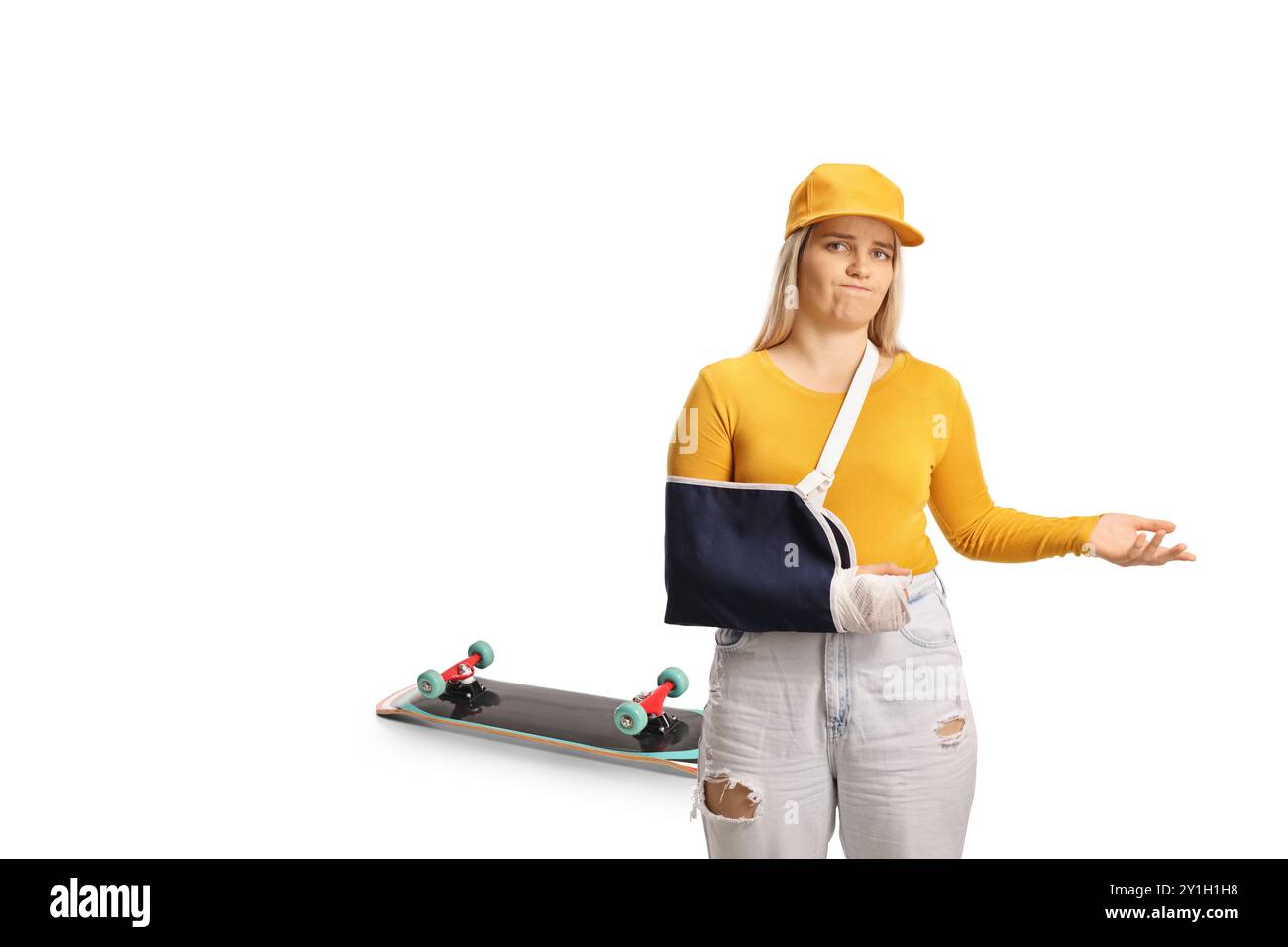 Young female with a skateboard and broken arm wearing an arm splint ...