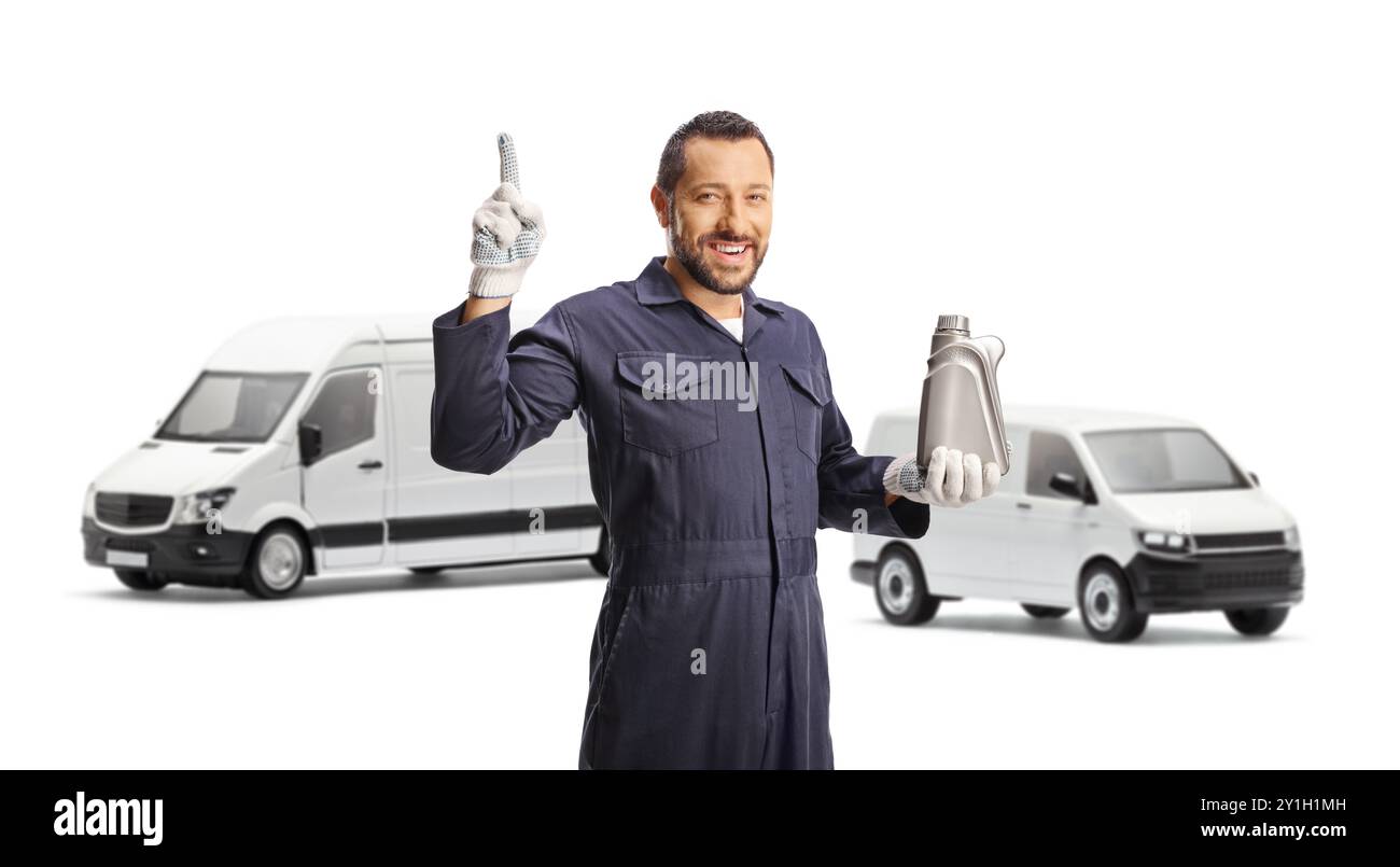 Car mechanic holding an engine oil for vans and pointing up isolated on ...