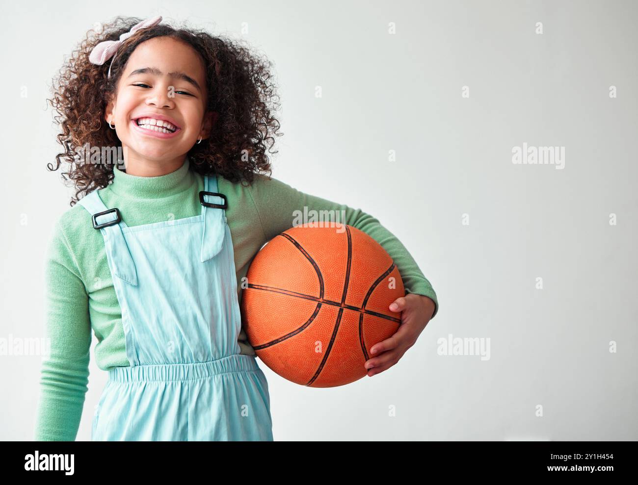 Kid, girl and happy with basketball in white background with sports for ...