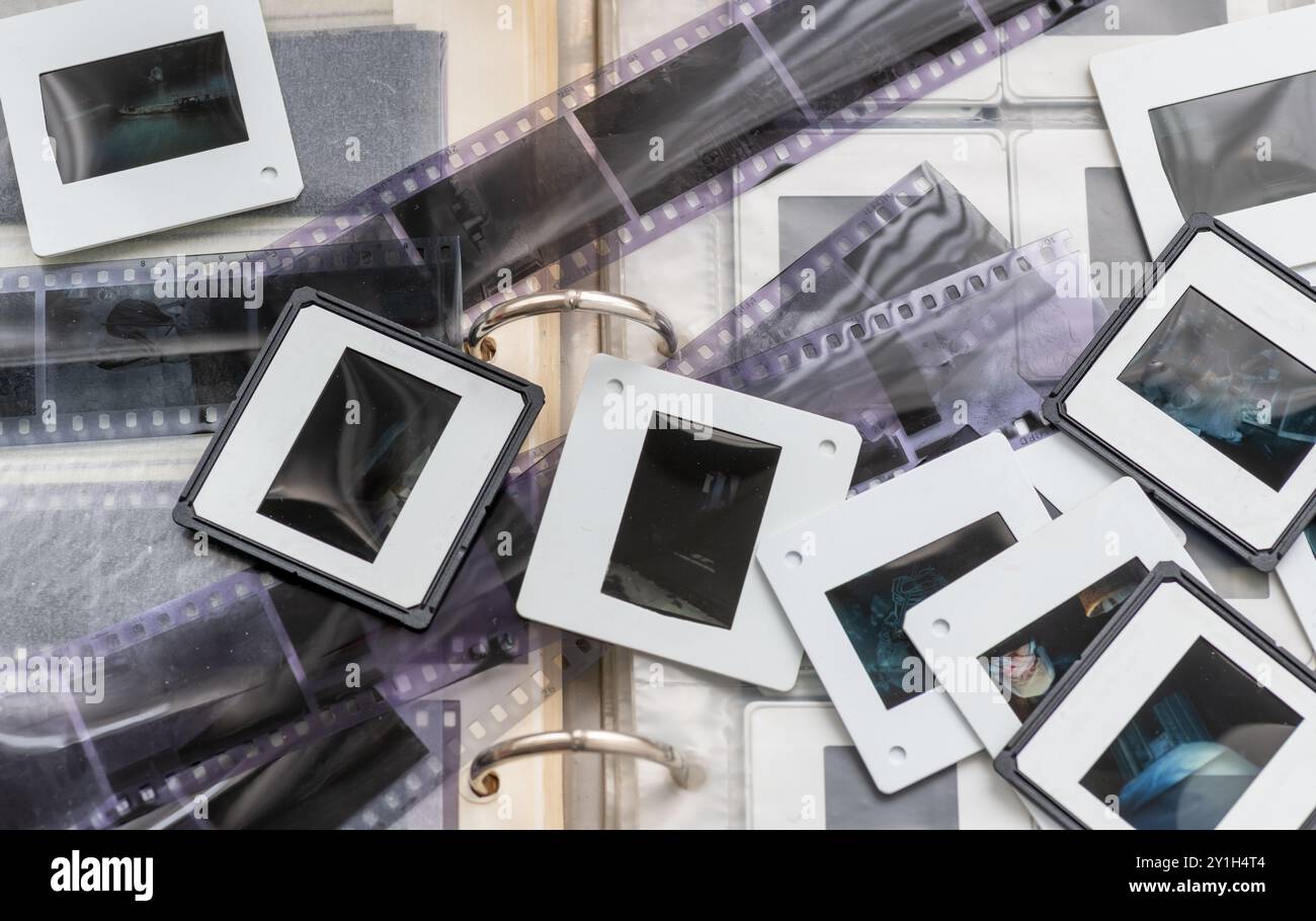 Black and white photo film strip negatives and colour slides on a ...