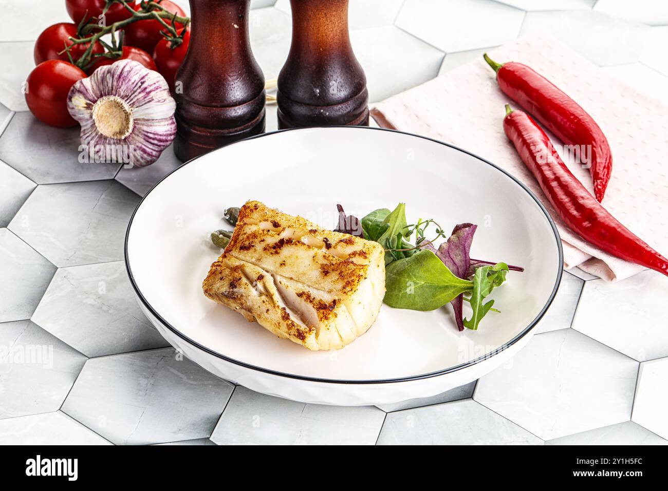 Roasted cod fish steak with salad leaves Stock Photo - Alamy