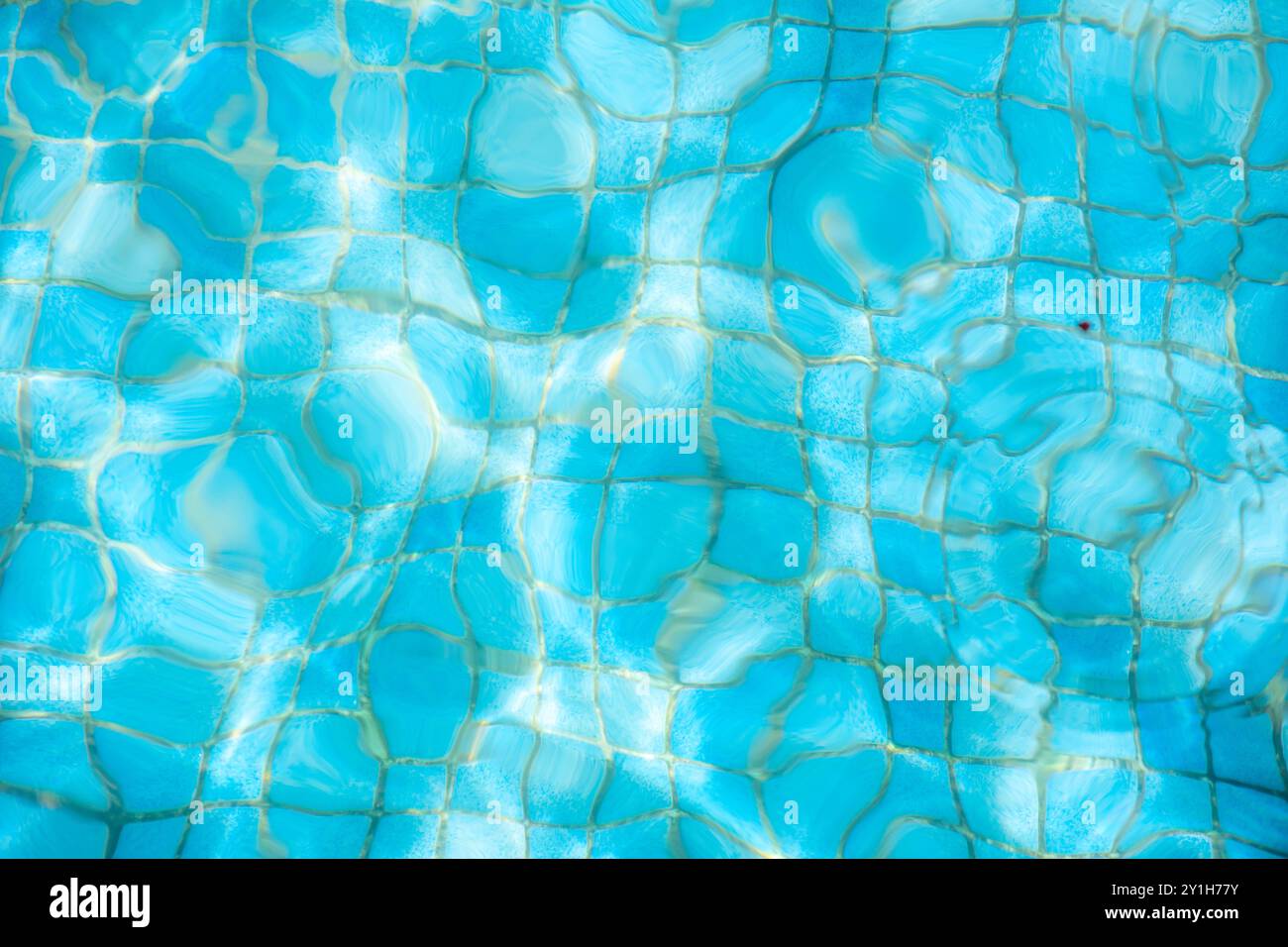 Blue water surface viewed from above in outdoor swimming pool, sun ...