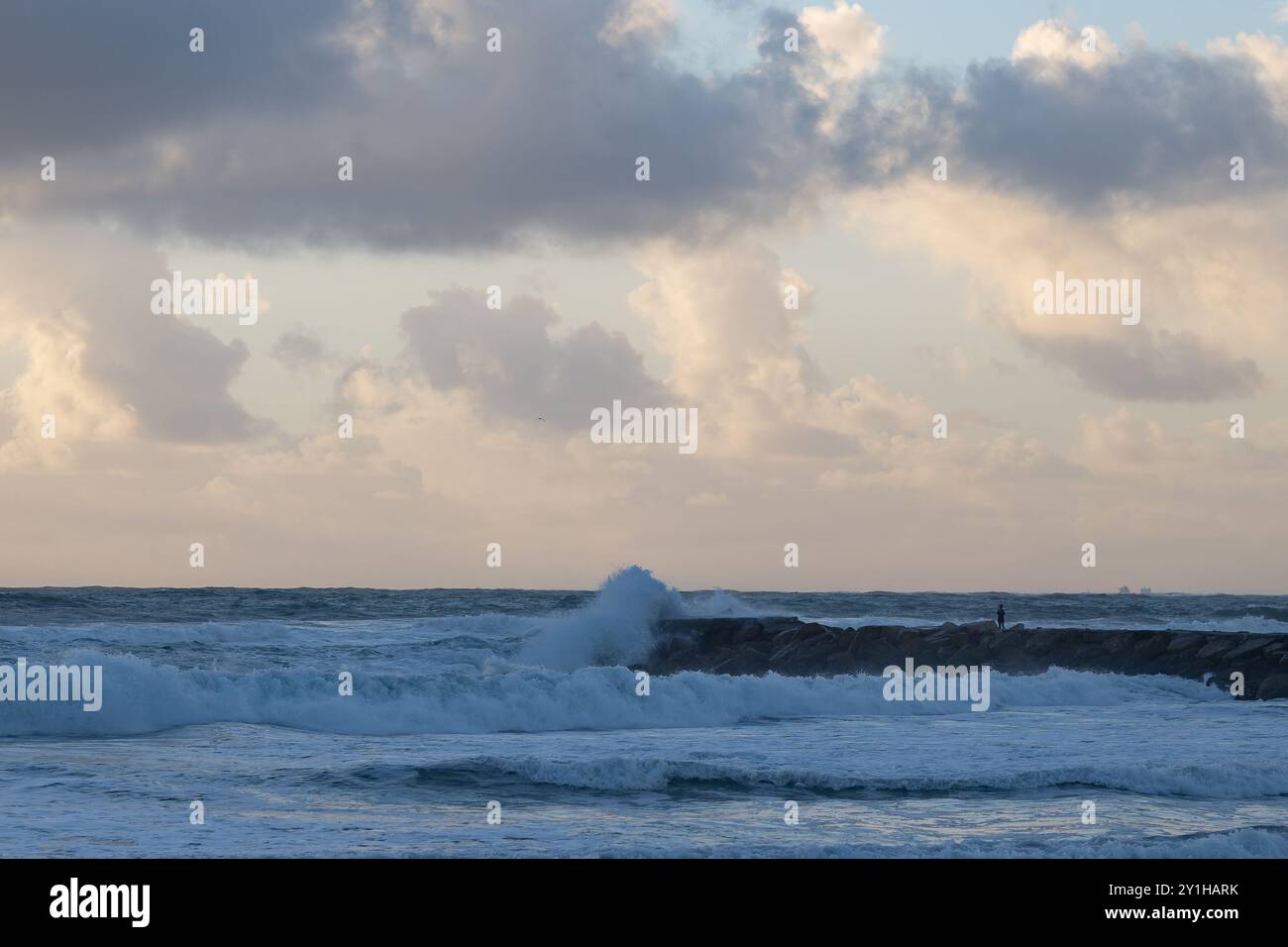 Sea waves crash against a stone ledge Stock Photo - Alamy