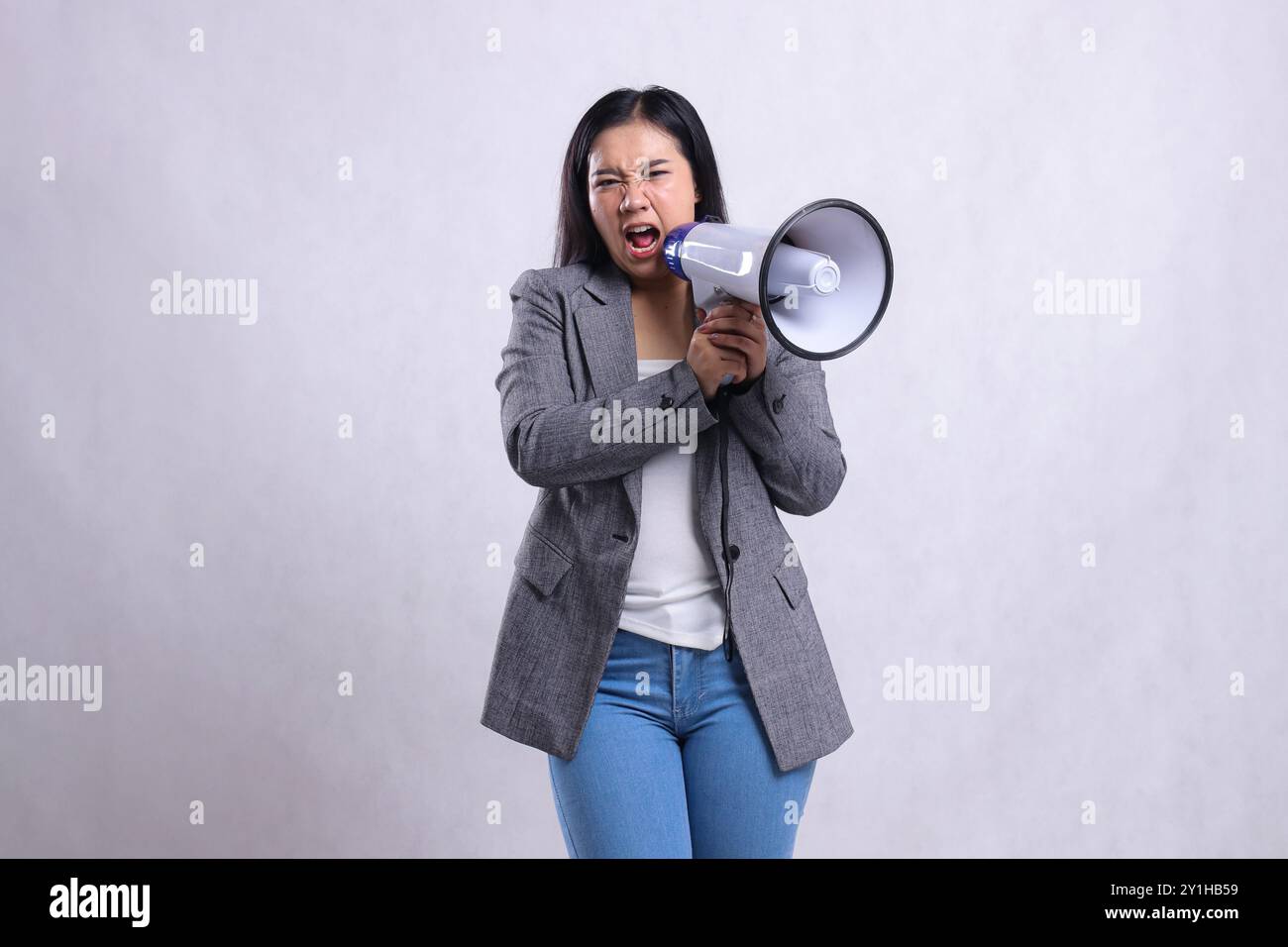 formal beautiful young lady screaming angry both hands holding ...