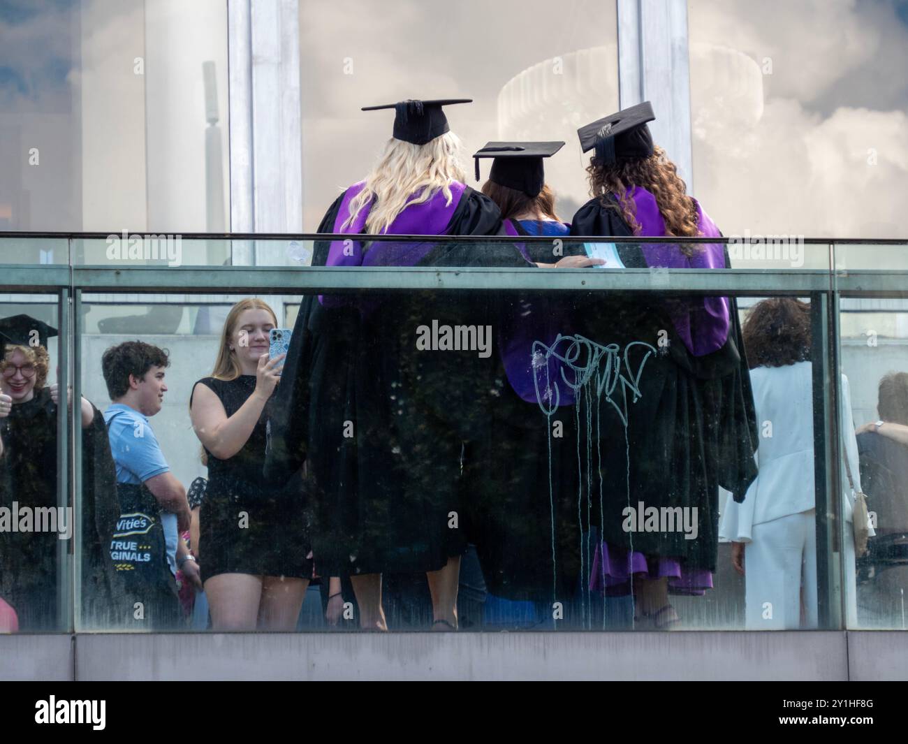 University graduates with capes and mortar boards at graduation ...