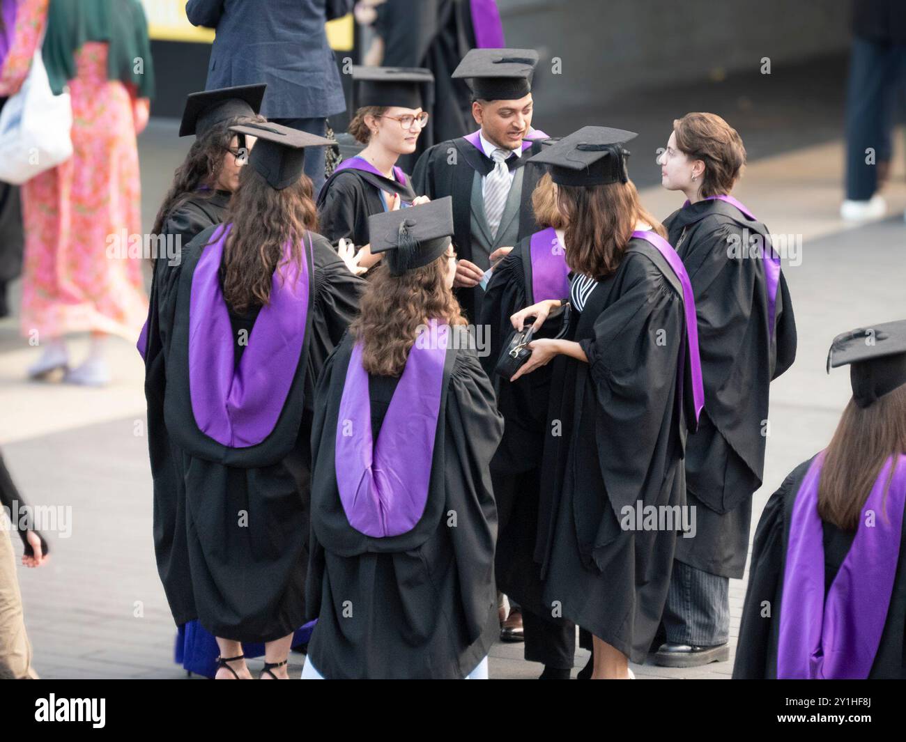 University graduates with capes and mortar boards at graduation ...