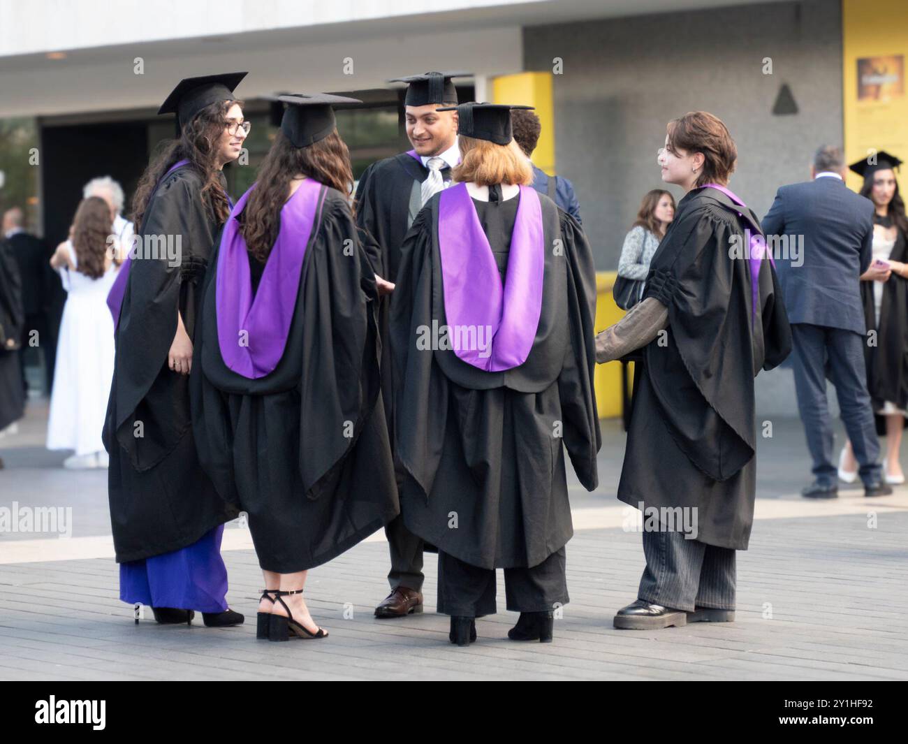University graduates with capes and mortar boards at graduation ...