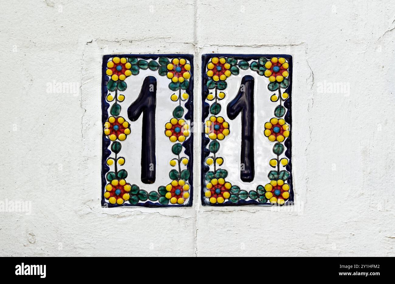 Street sign number 11 on a wite wall in the Tijuca neighborhood, Rio de ...