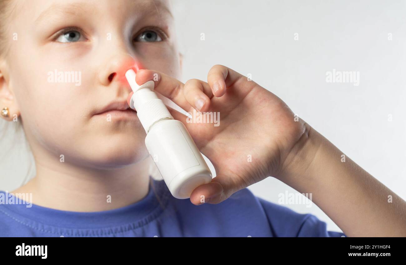 A caucasian girl puts drops into her nose and an anti-inflammatory ...