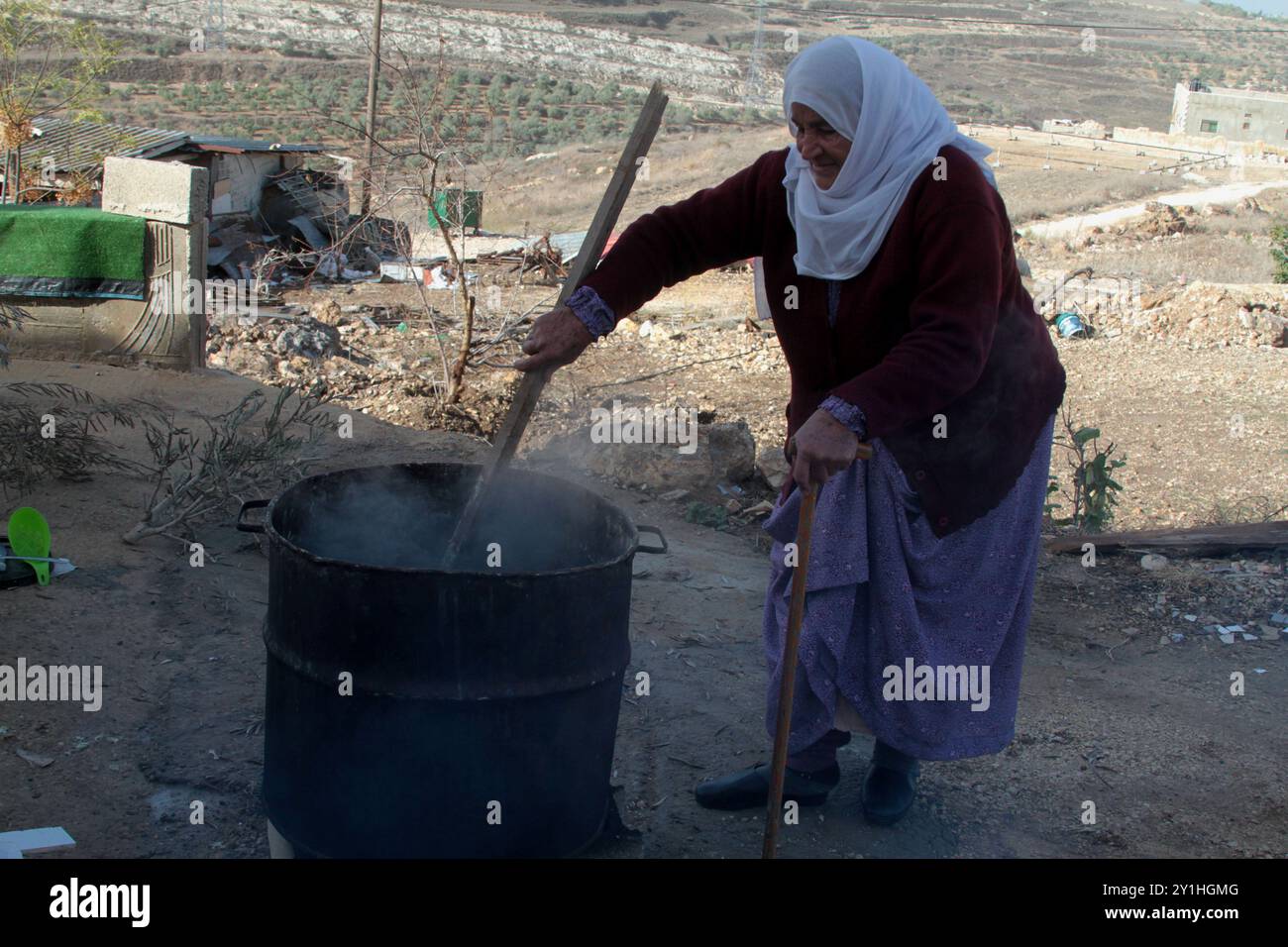 An elderly Palestinian woman mix olive oil with water and alkaline ...