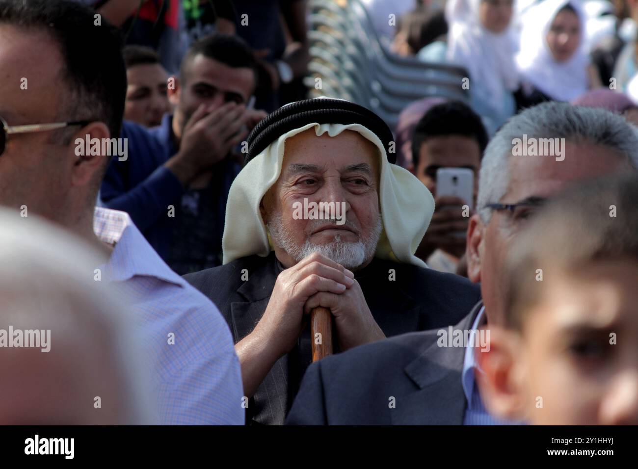 Palestinians watch the raising of a Palestinian flag during a rally ...