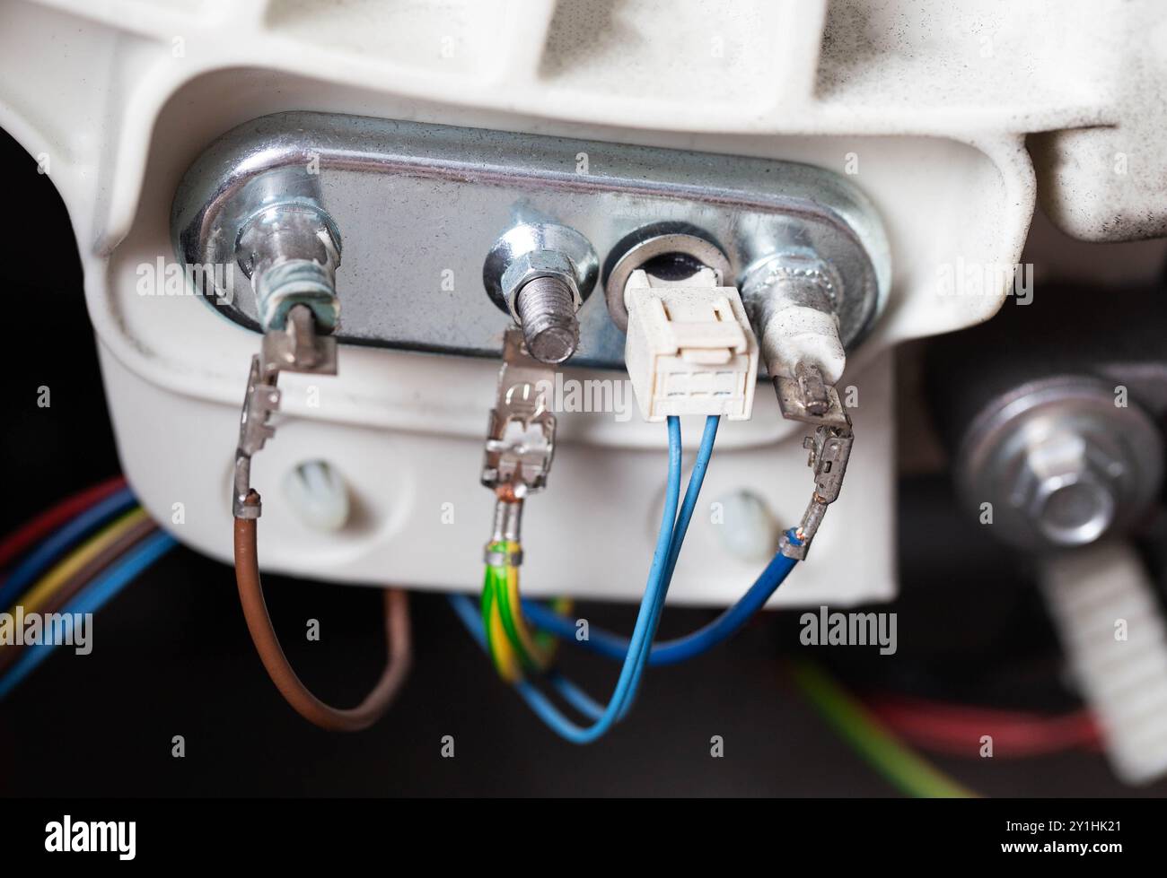 An electric heating element with a thermostat is connected with ...