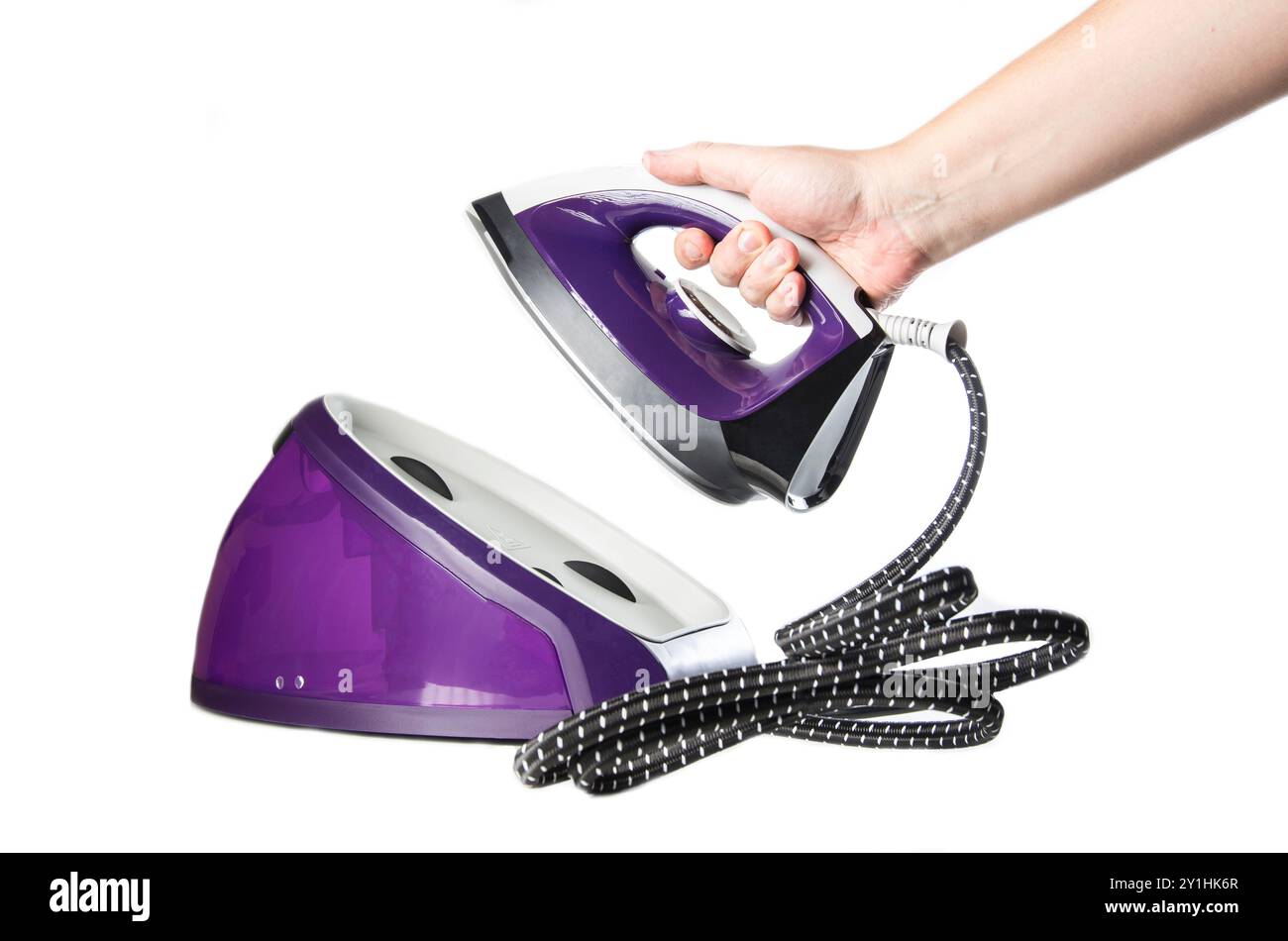 Modern ceramic iron with a steam generator in hand on a white ... Modern ceramic iron with a steam generator in hand on a white ...