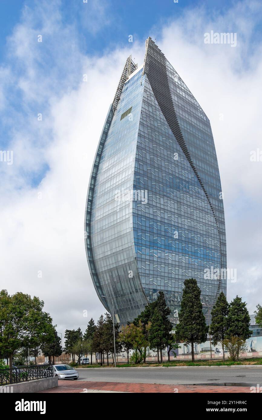 The Azersu Tower stands tall against a cloudy sky in Baku, Azerbaijan ...