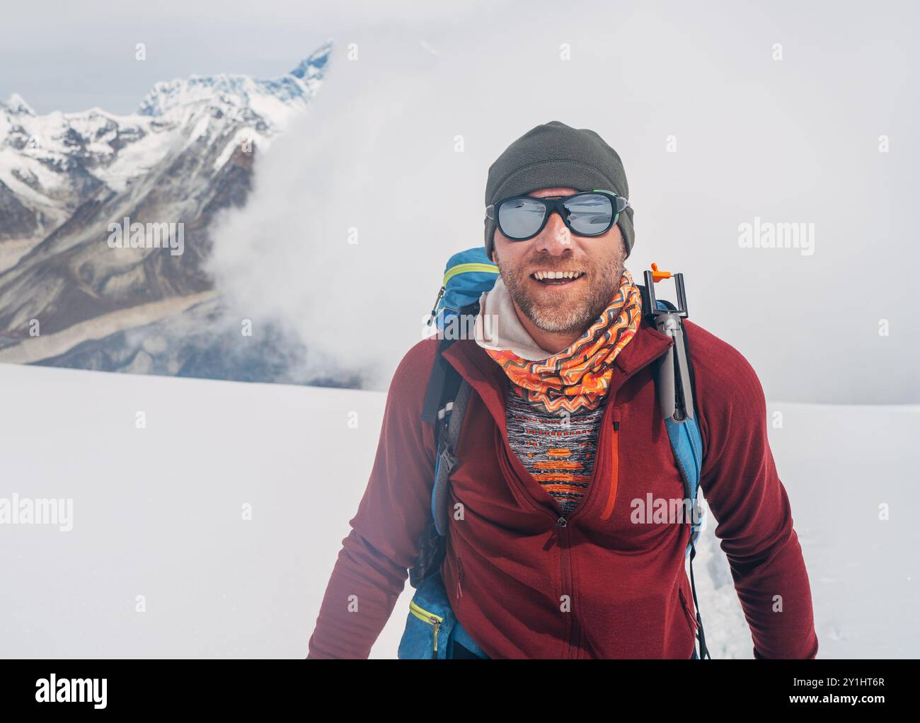 Cheerful laughing climber in sunglasses portrait with backpack ...