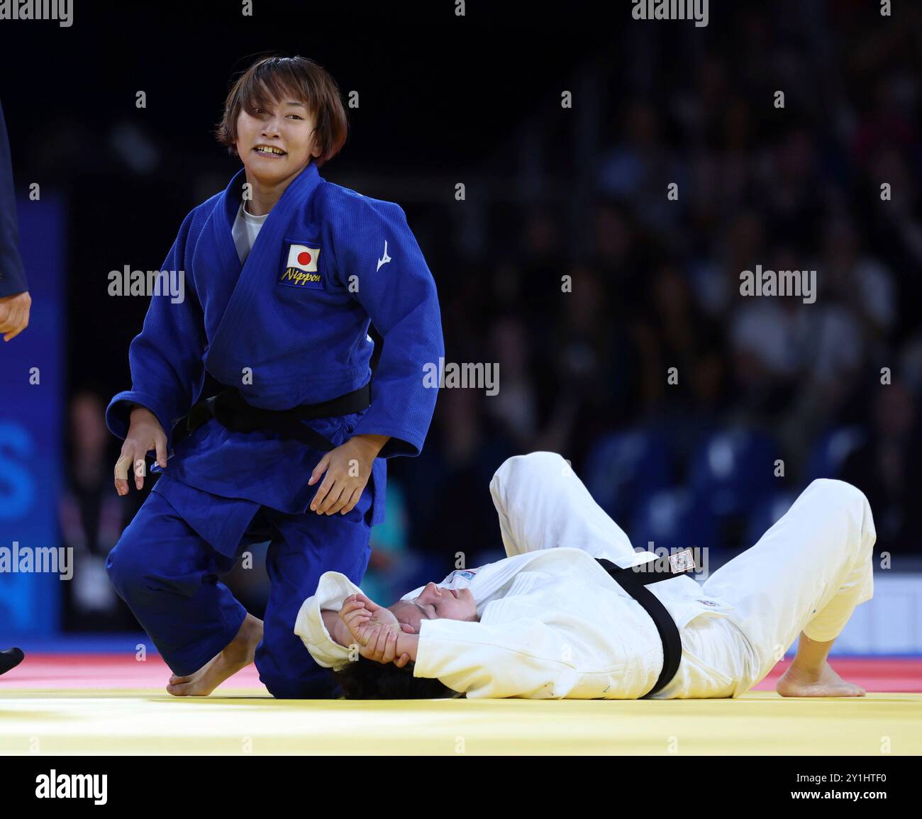 HIROSE Junko of Japan (in blue) reacts after winning the women's judo -57kg final against ...
