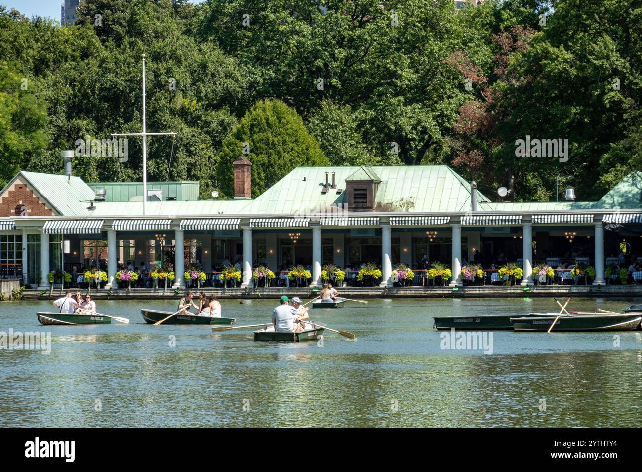 Visitors enjoy boating on the Lake in Central Park, New York City, USA ...