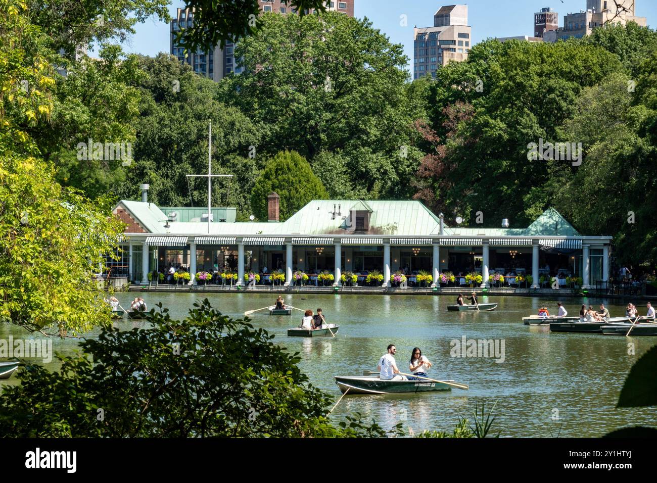 Visitors enjoy boating on the Lake in Central Park, New York City, USA ...