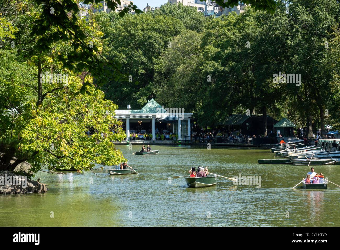 Visitors enjoy boating on the Lake in Central Park, New York City, USA ...