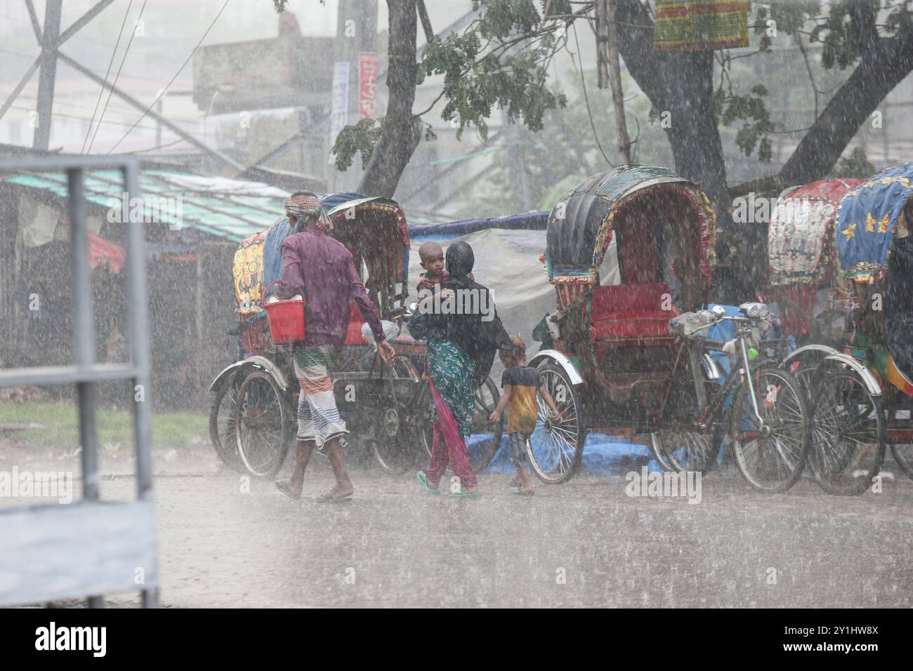 Monsoon Rain in Dhaka, Bangladesh A rickshaw puller makes his way along a street during heavy ...