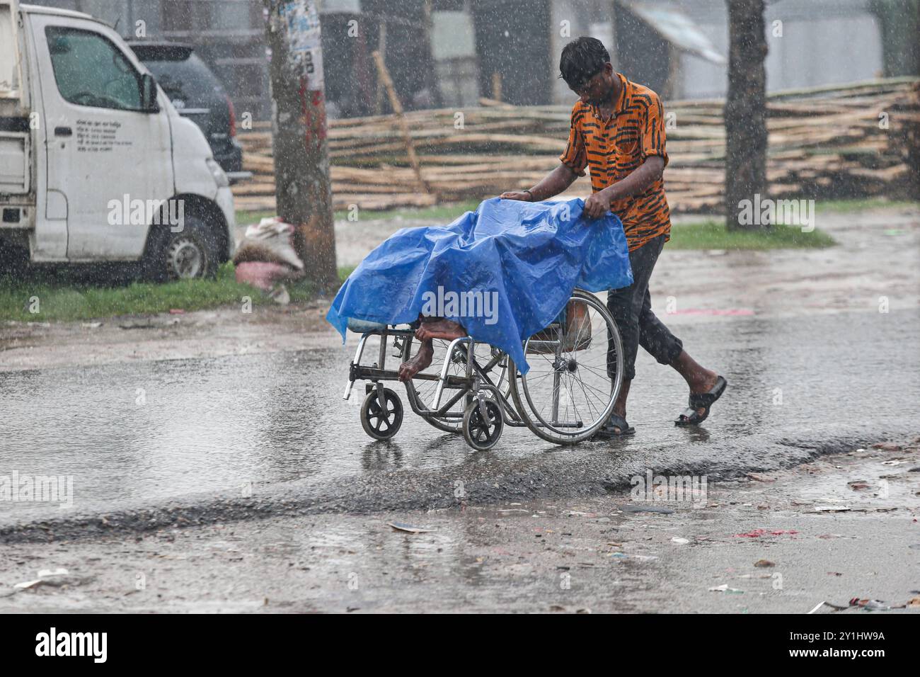 Monsoon Rain in Dhaka, Bangladesh People crosses a street during heavy rainfall in Dhaka on ...