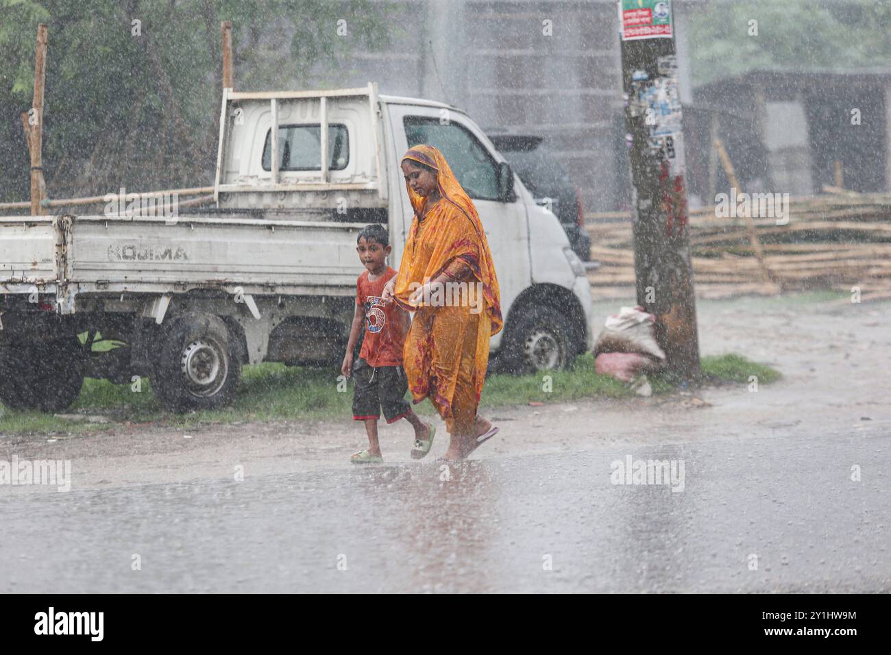 Monsoon Rain in Dhaka, Bangladesh People crosses a street during heavy rainfall in Dhaka on ...