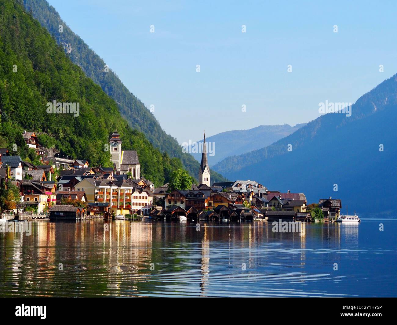 A serene lakeside Hallstatt in Austria, boasting colorful houses, a ...