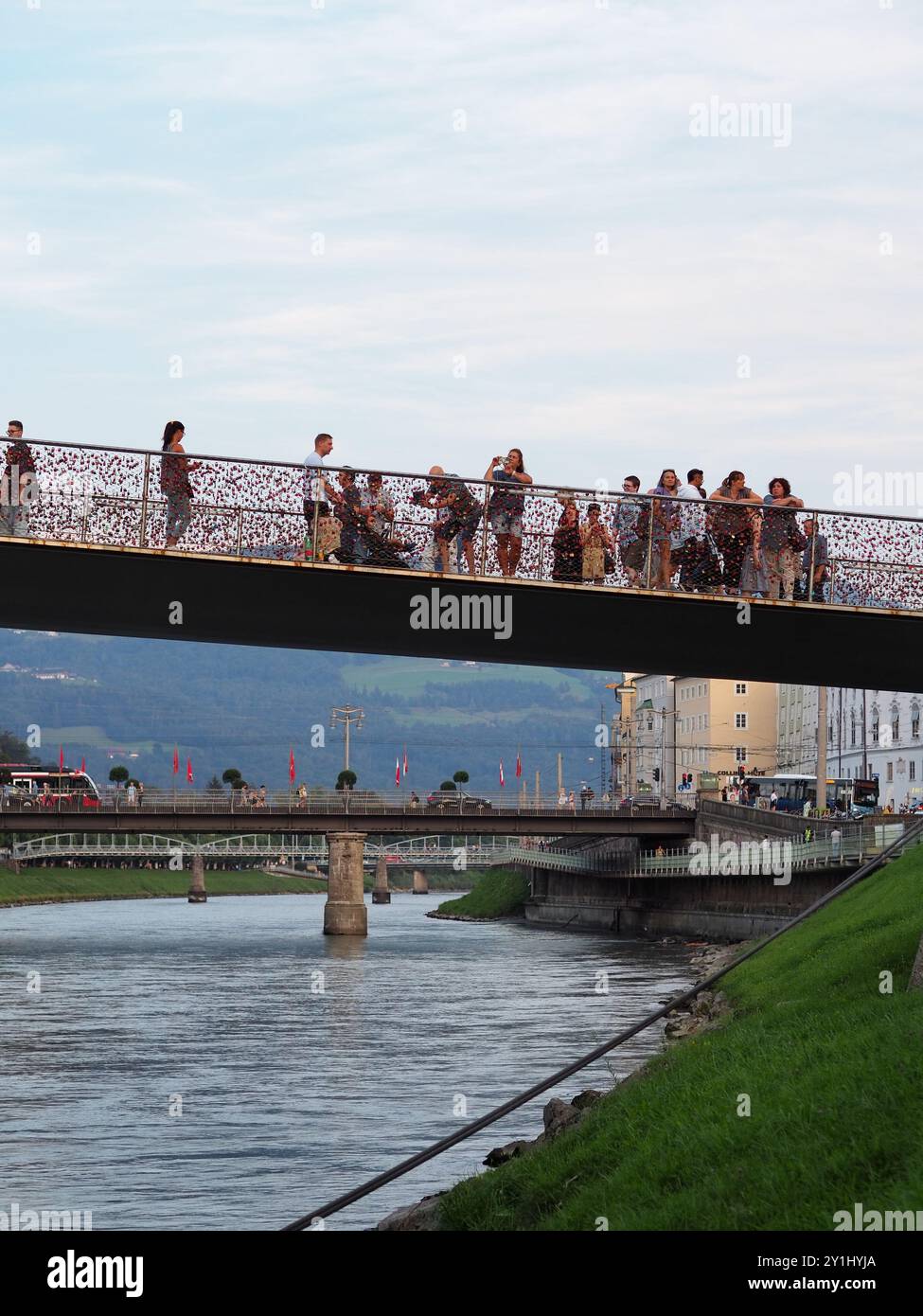 Salzburg, Austria - 31 Aug, 2024: A bustling pedestrian bridge filled ...