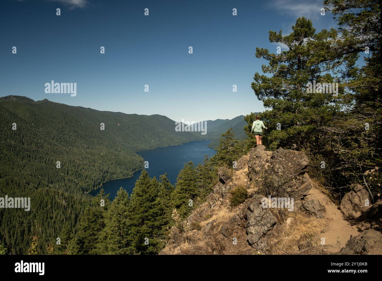 Woman Stands at Summit of Mount Storm King Looking Over Crescent Lake ...