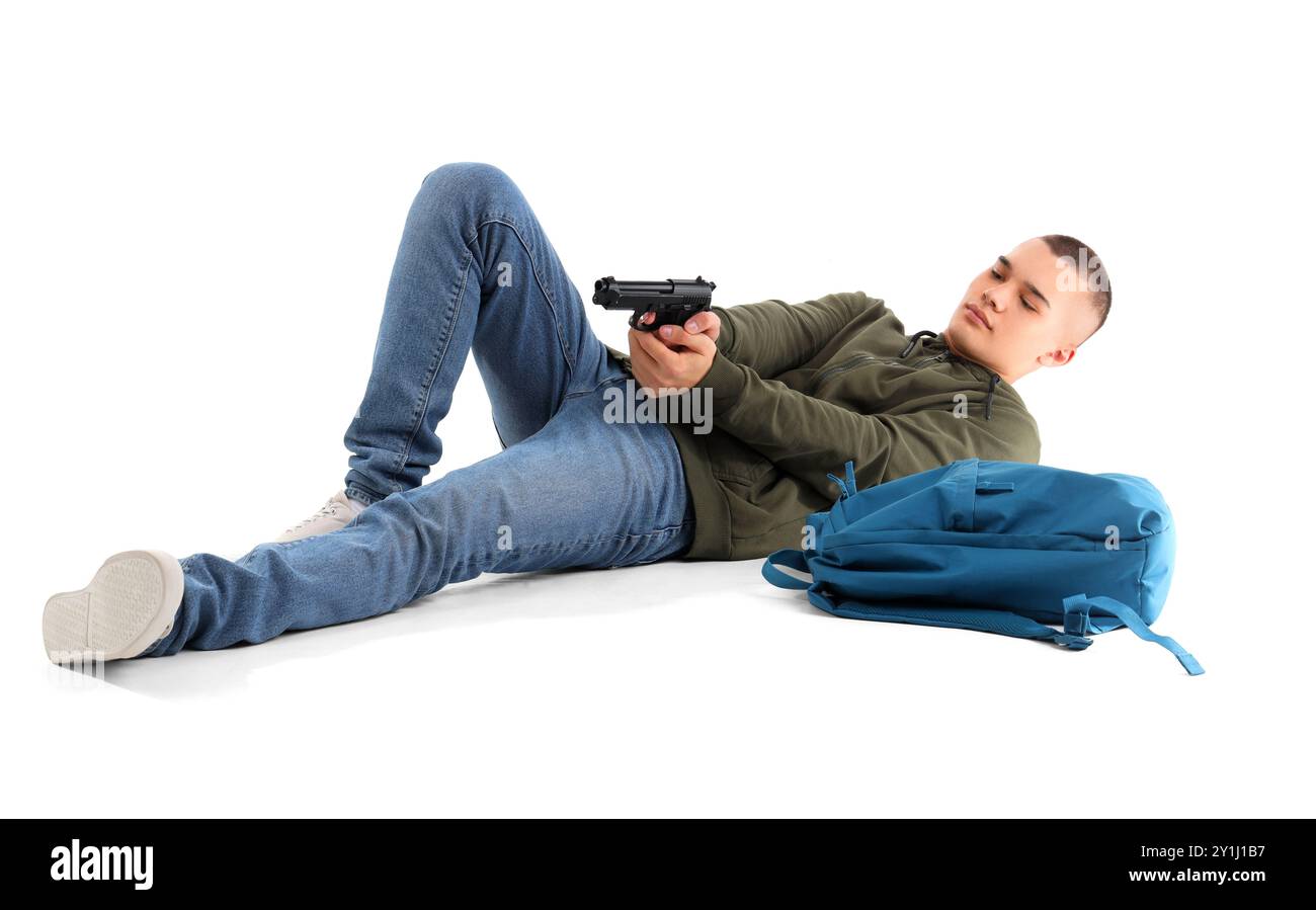 Male student with gun lying on white background. School shooting ...