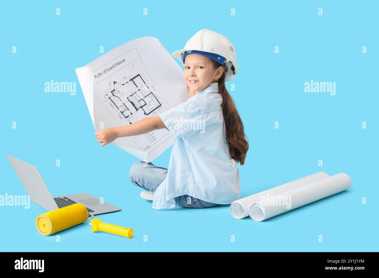 Cute little architect reading blueprint on blue background Stock Photo ...